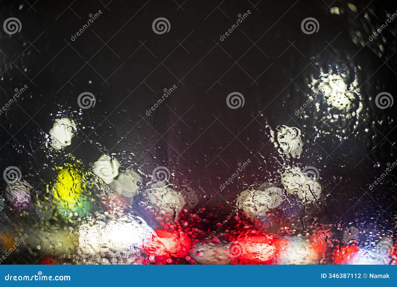 Reflections of Lights from a Car Windshield in the Rain in a Traffic ...