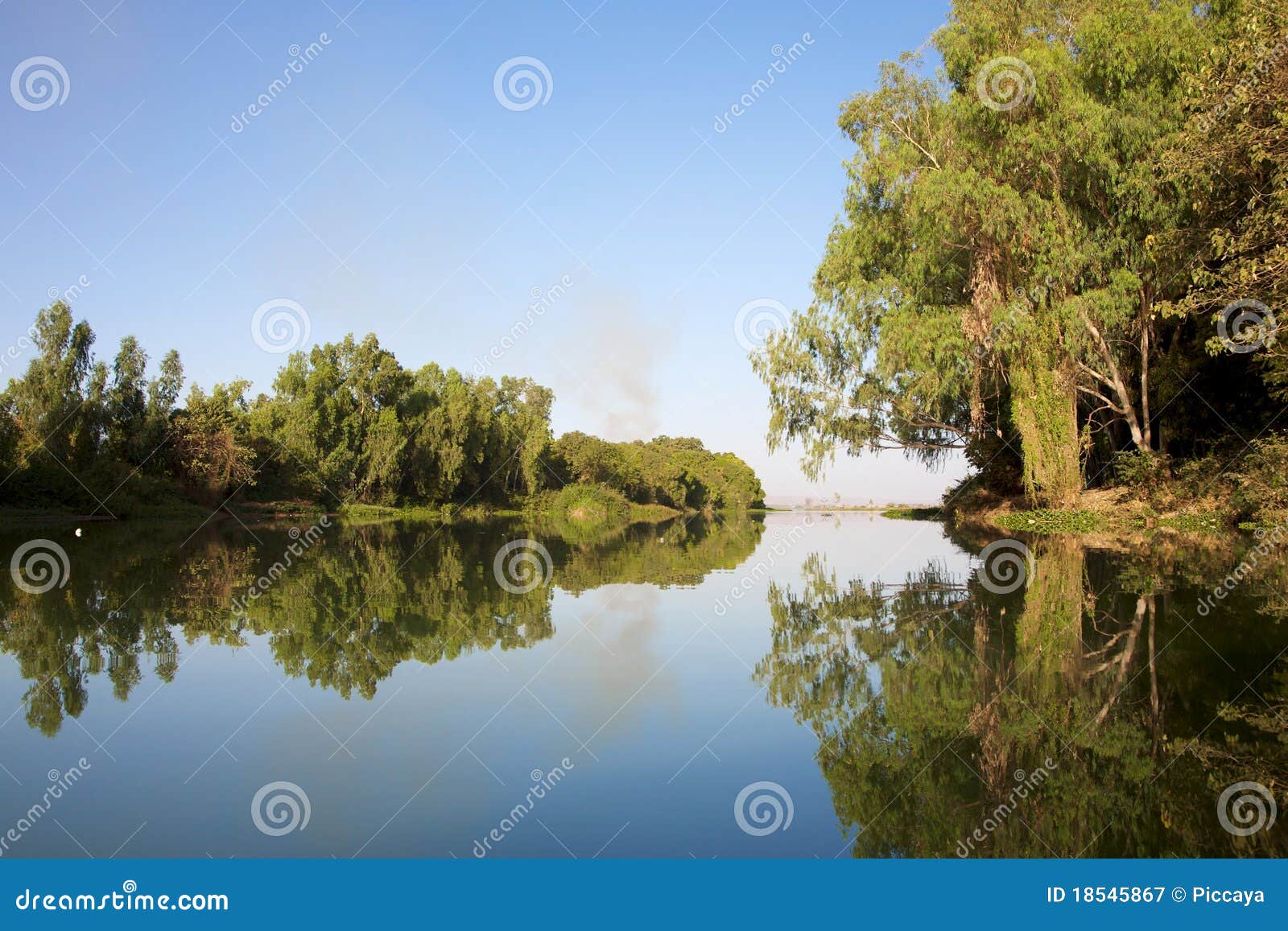Reflections in the river stock image. Image of lake, natural - 18545867