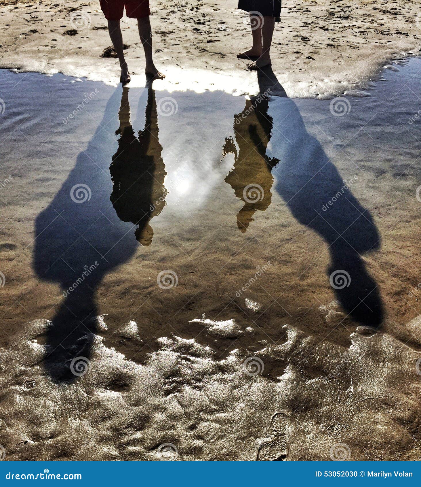Reflections and Tall Shadows at the Beach Stock Photo - Image of stand ...