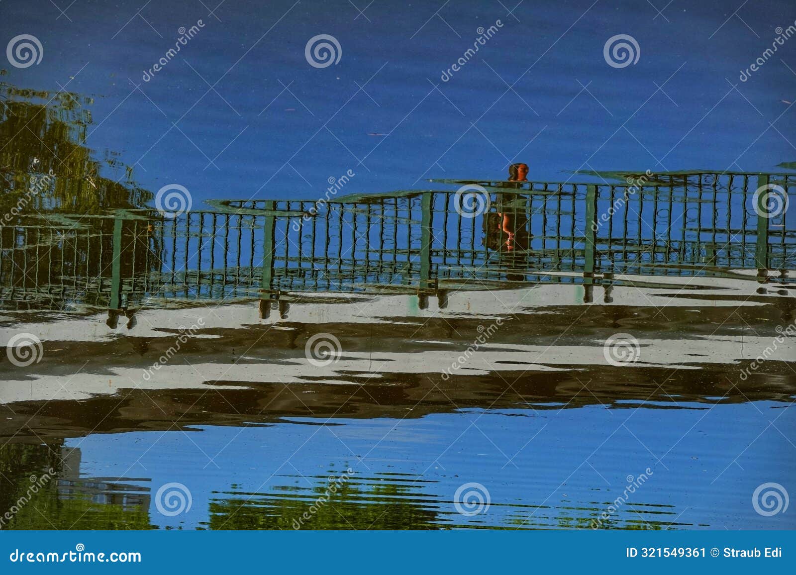 Reflections in the Water of Passers-by on the Bridge Stock Image ...