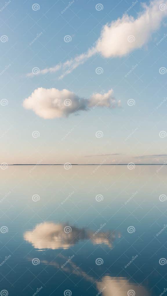 Reflective Clouds Over a Still Blue Water Surface. Stock Image - Image of formations, nebulae ...
