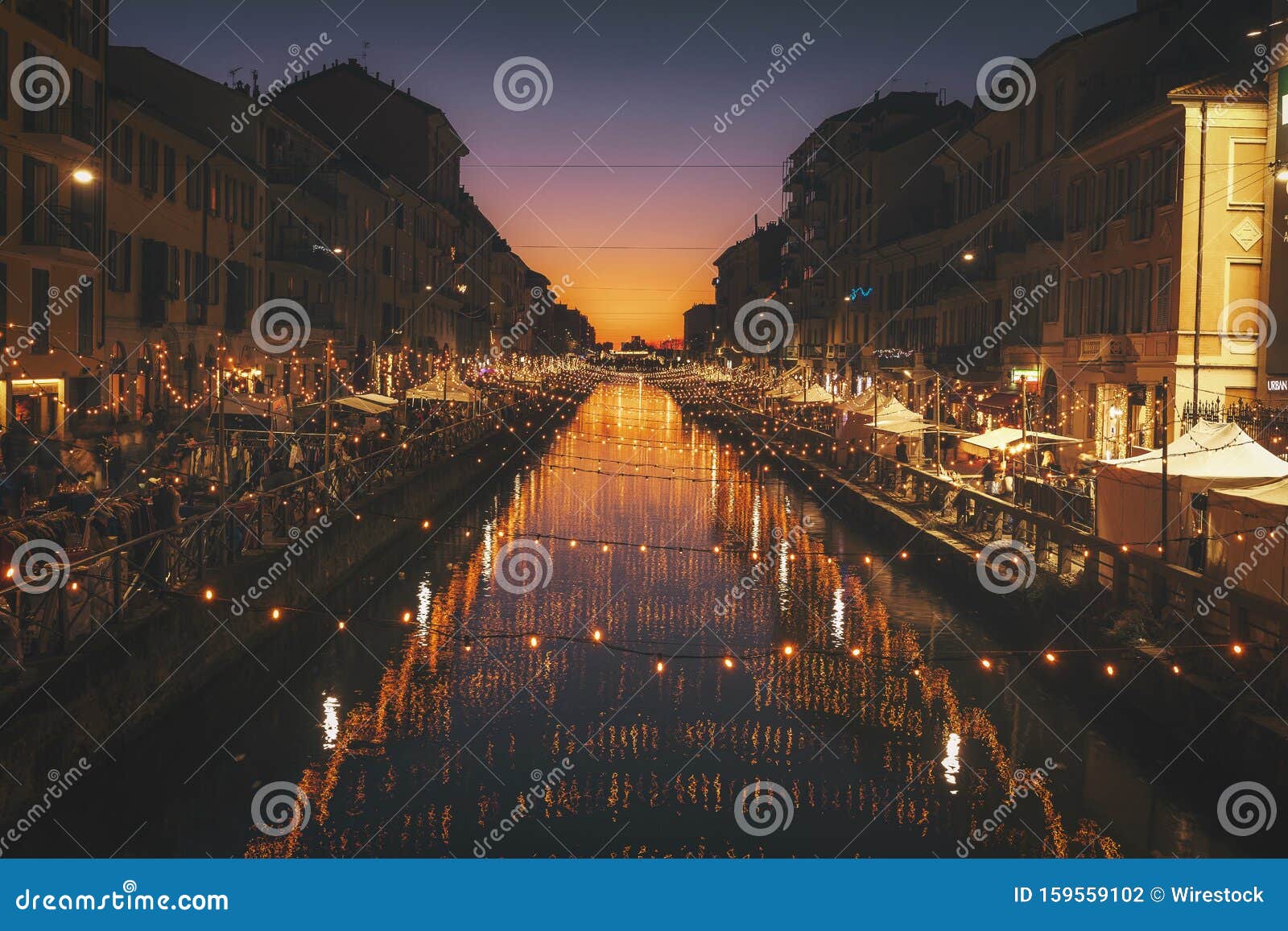 Reflective Shot of String Lights Above River between the Buildings ...