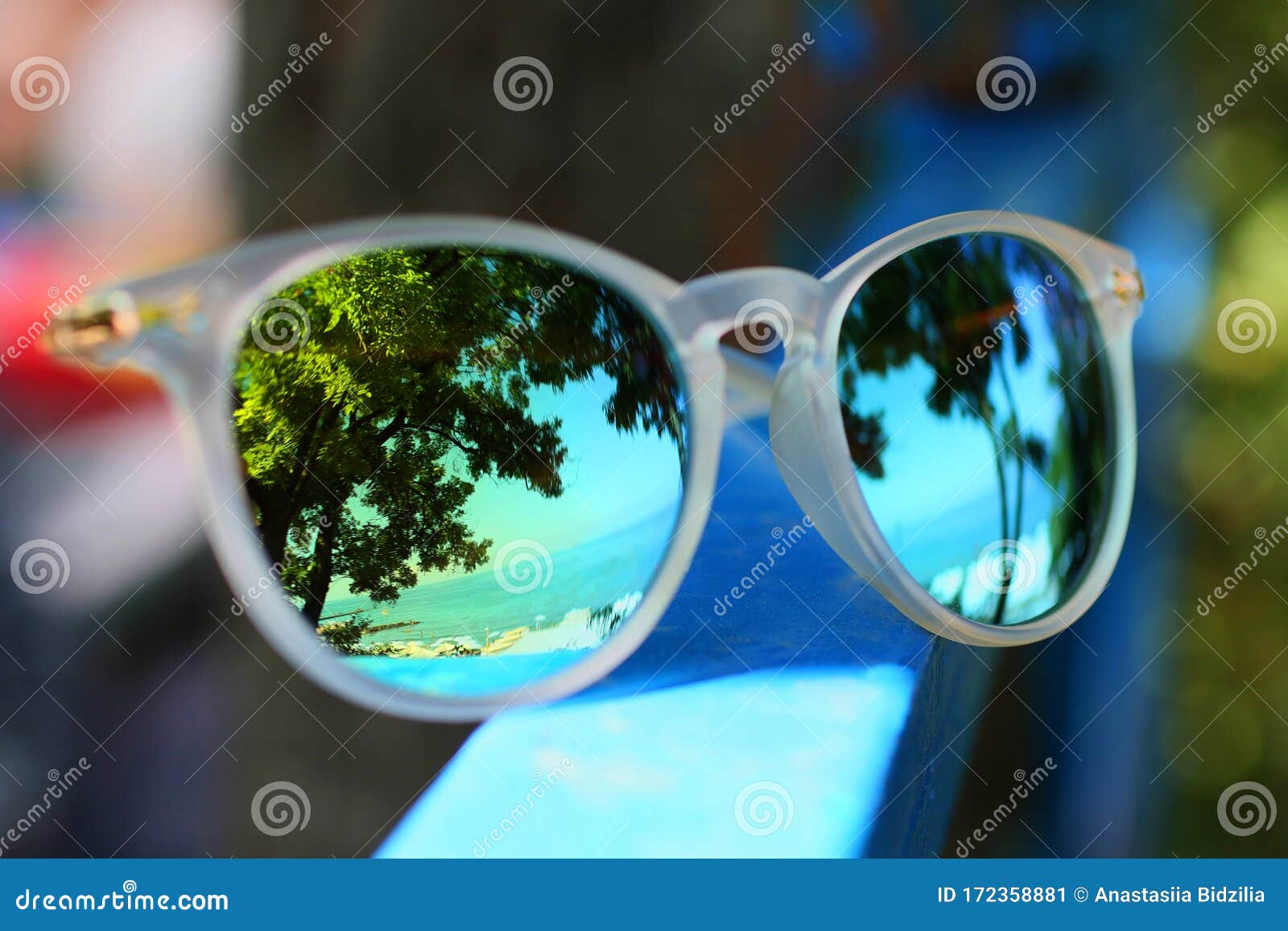 Reflective Sunglasses With Reflection Of The Sea And Trees Summer