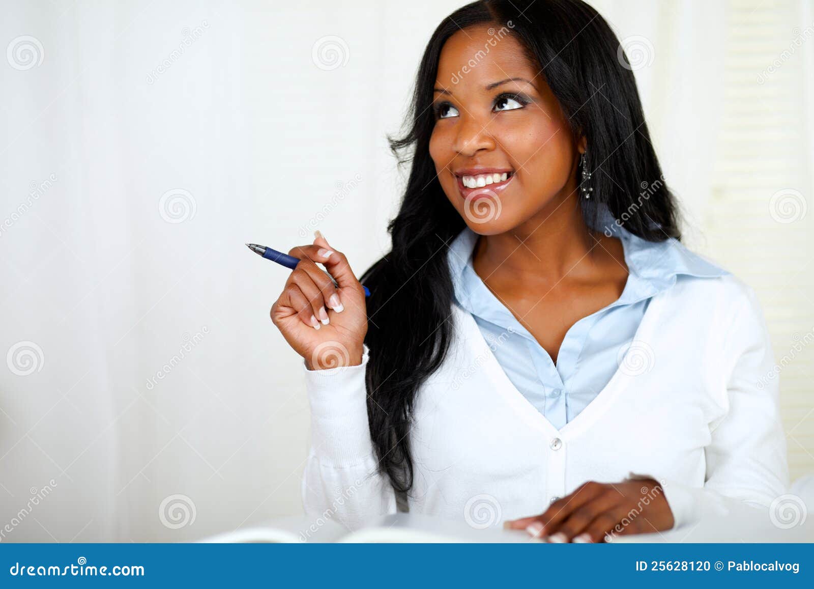 Reflective Young Woman Smiling and Studying Stock Photo - Image of ...