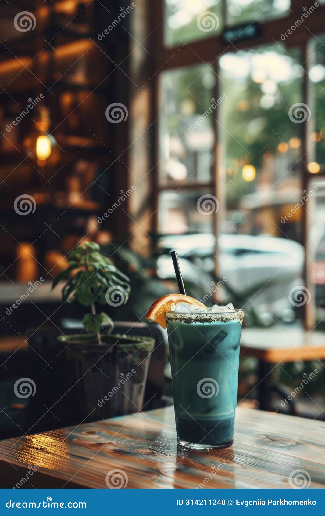 Refreshing Blue Lagoon Cocktail on Rustic Cafe Table with Warm Ambient ...