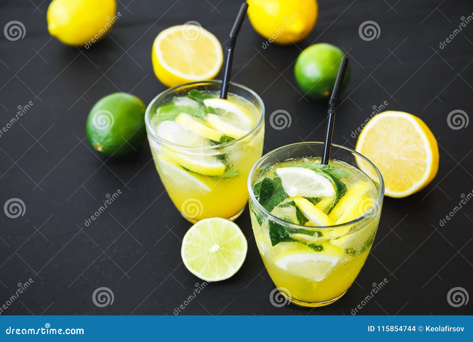 Refreshing Lemonade in Glass with Limes, Lemons Stock Photo - Image of ...