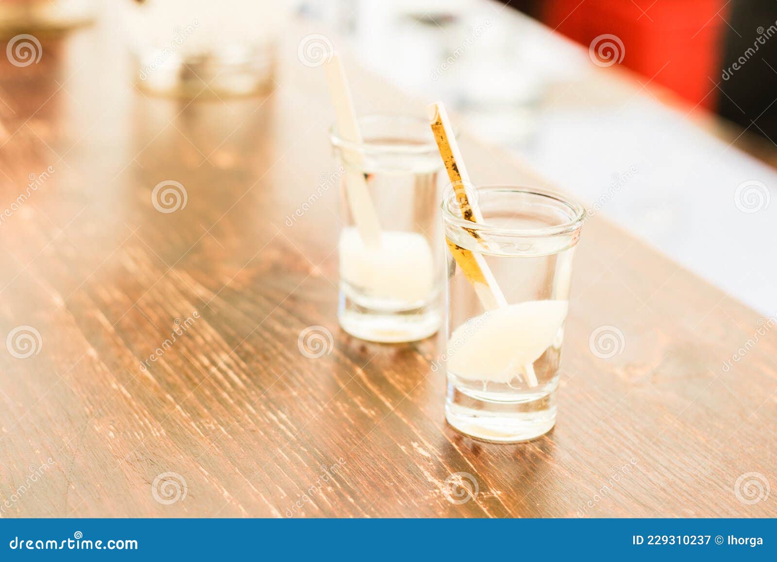 2 Refreshing Shots of Alcohol on Wooden Table Stock Image - Image of ...