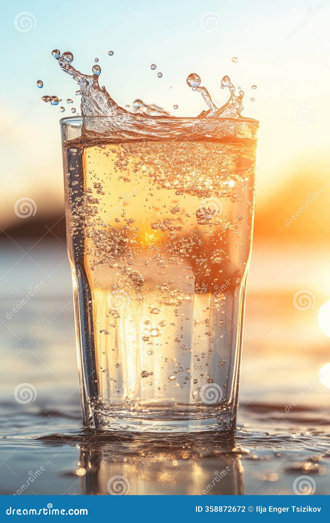 Refreshing Splash, Sparkling Water and Ice in Glass at Sunset, with ...
