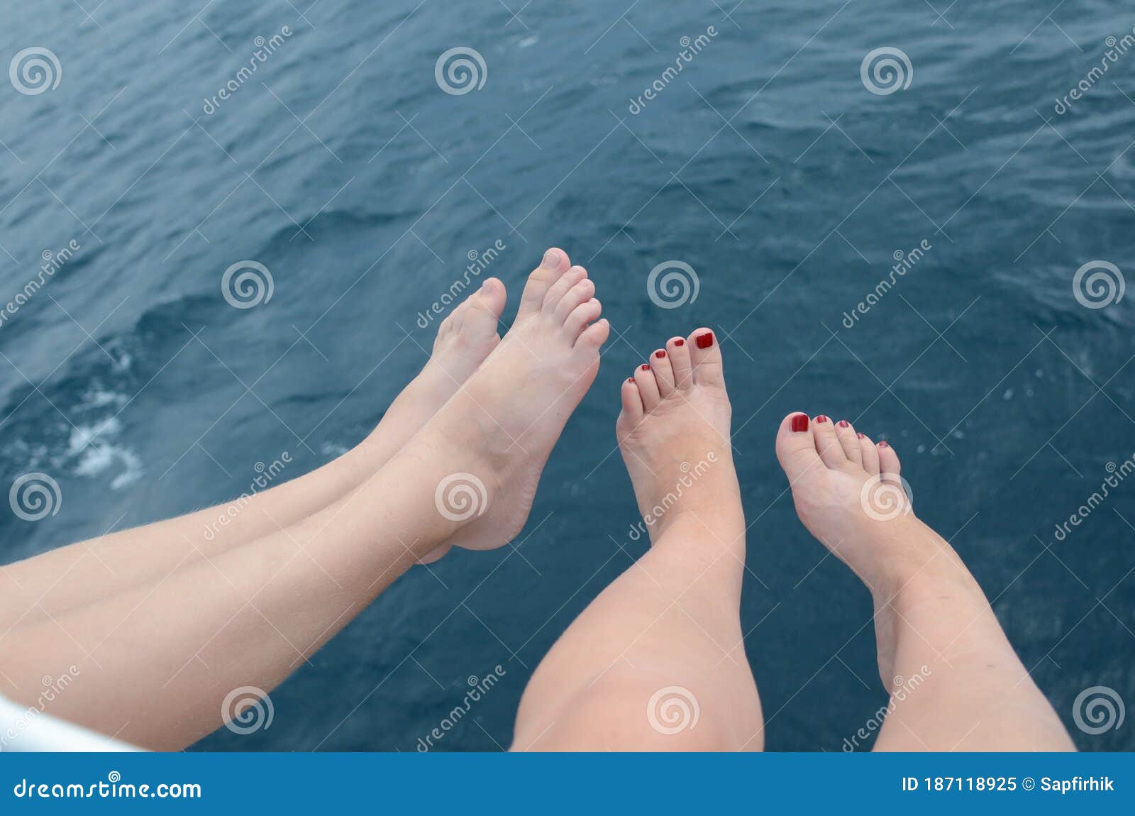 Legs over the ocean stock image. Image of holiday, foot - 187118925