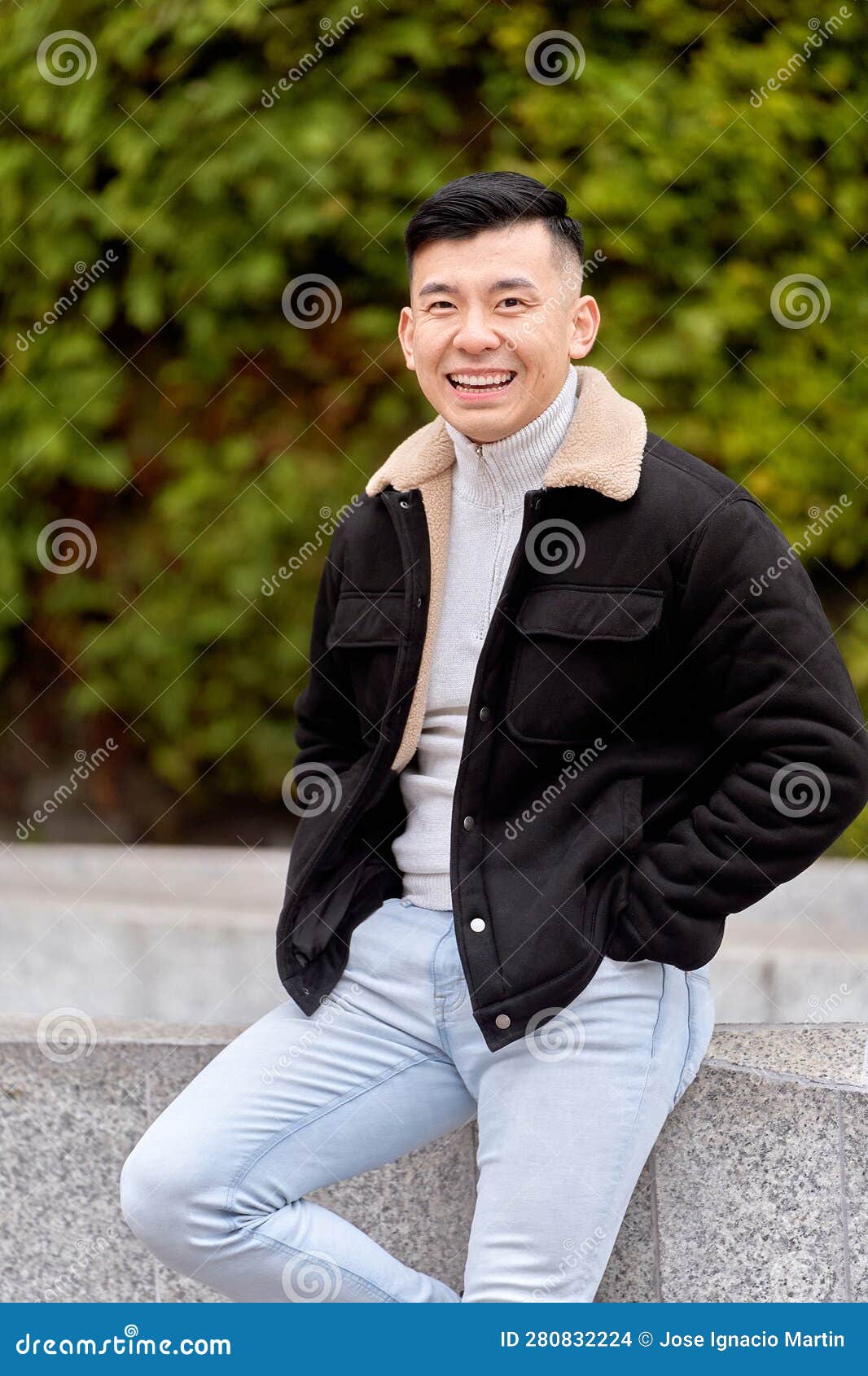 Relaxed Asian Man Looking at Camera and Smiling while Posing Outdoors ...