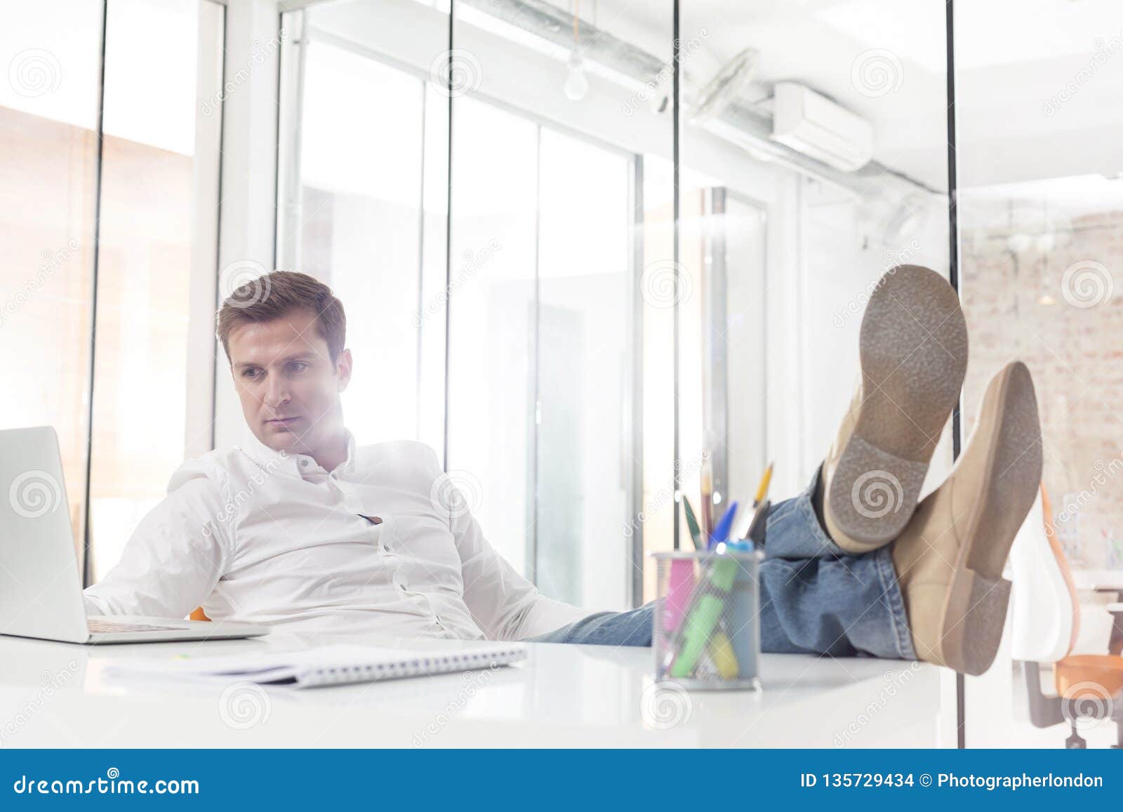 Relaxed Businessman Using Laptop in Office Stock Photo - Image of ...