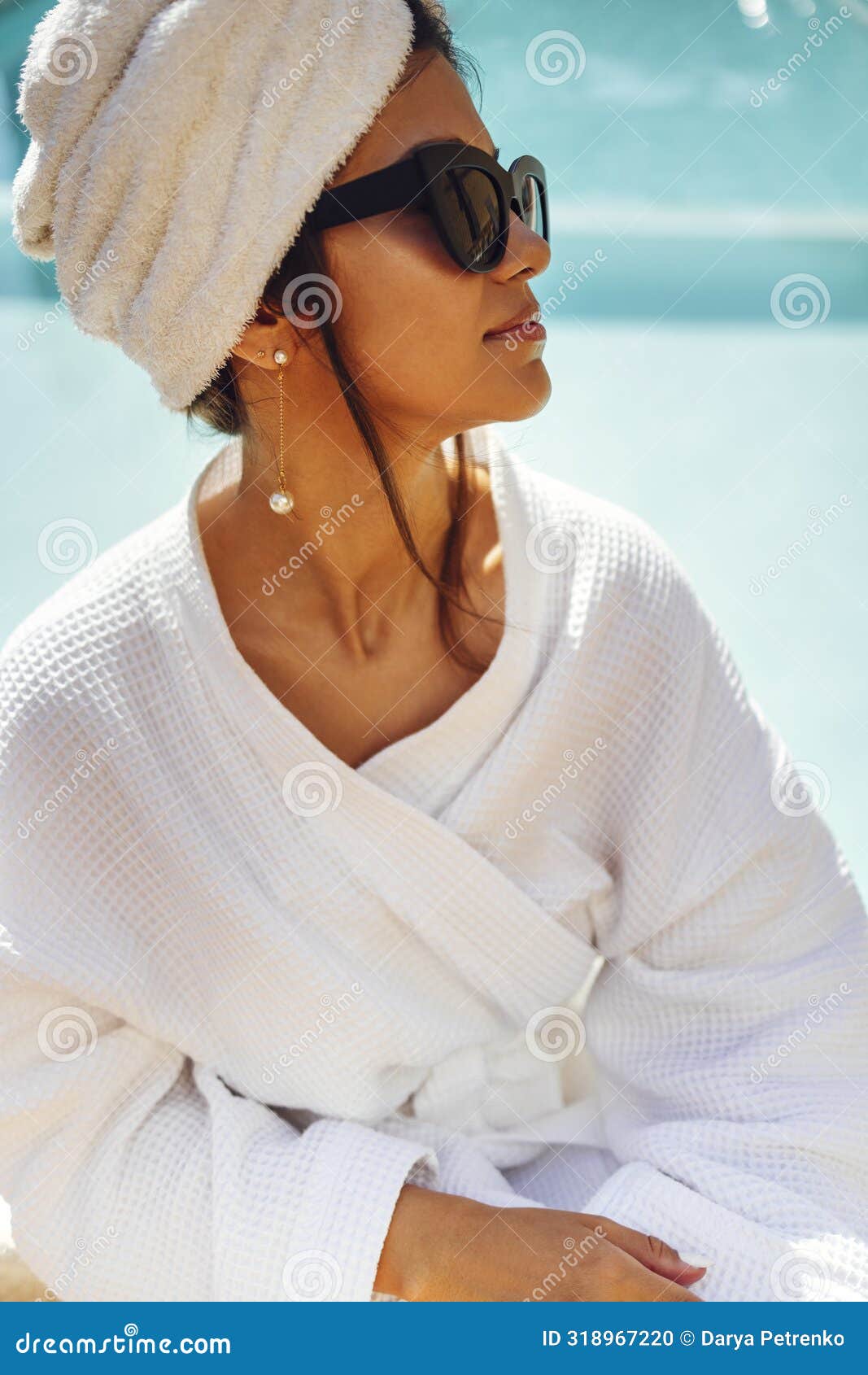 Relaxed Caucasian Female In Sunglasses And A Towel On Her Head Sits At