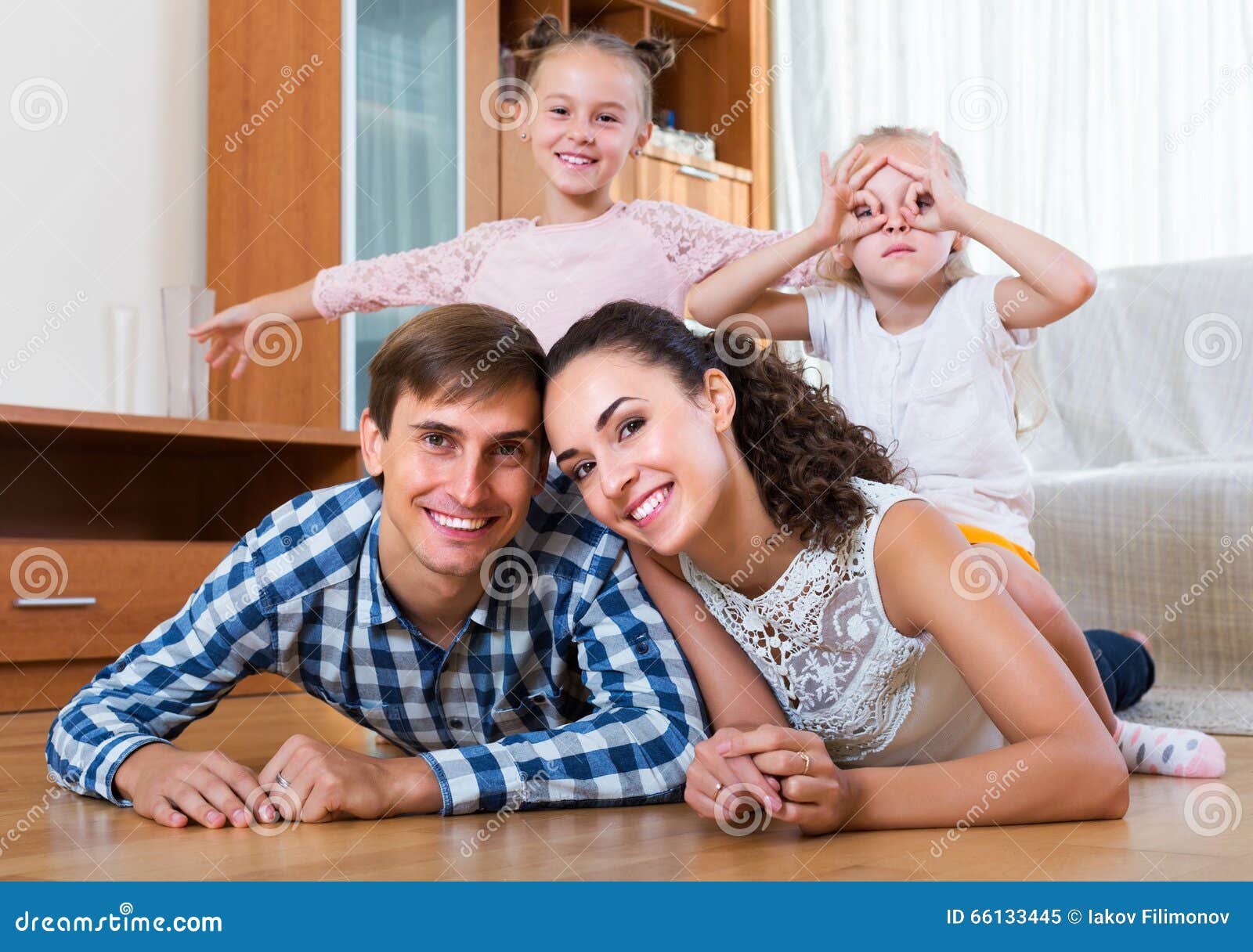 Relaxed Family of Four Posing Stock Image - Image of smiling, relaxed ...