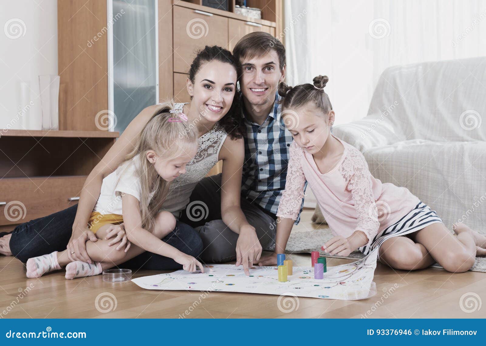 Relaxed Family of Four Posing Stock Photo - Image of lounge, sitting ...