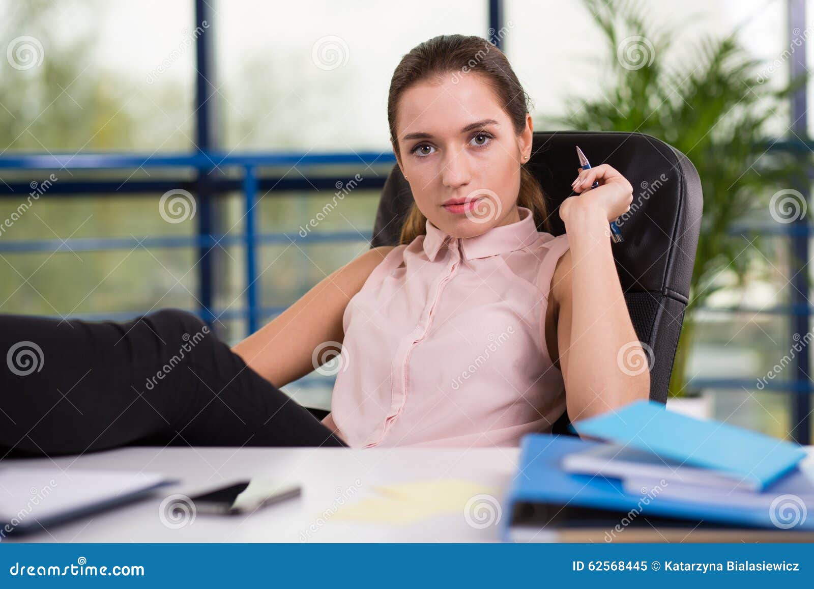Relaxed female manager stock image. Image of sitting - 62568445