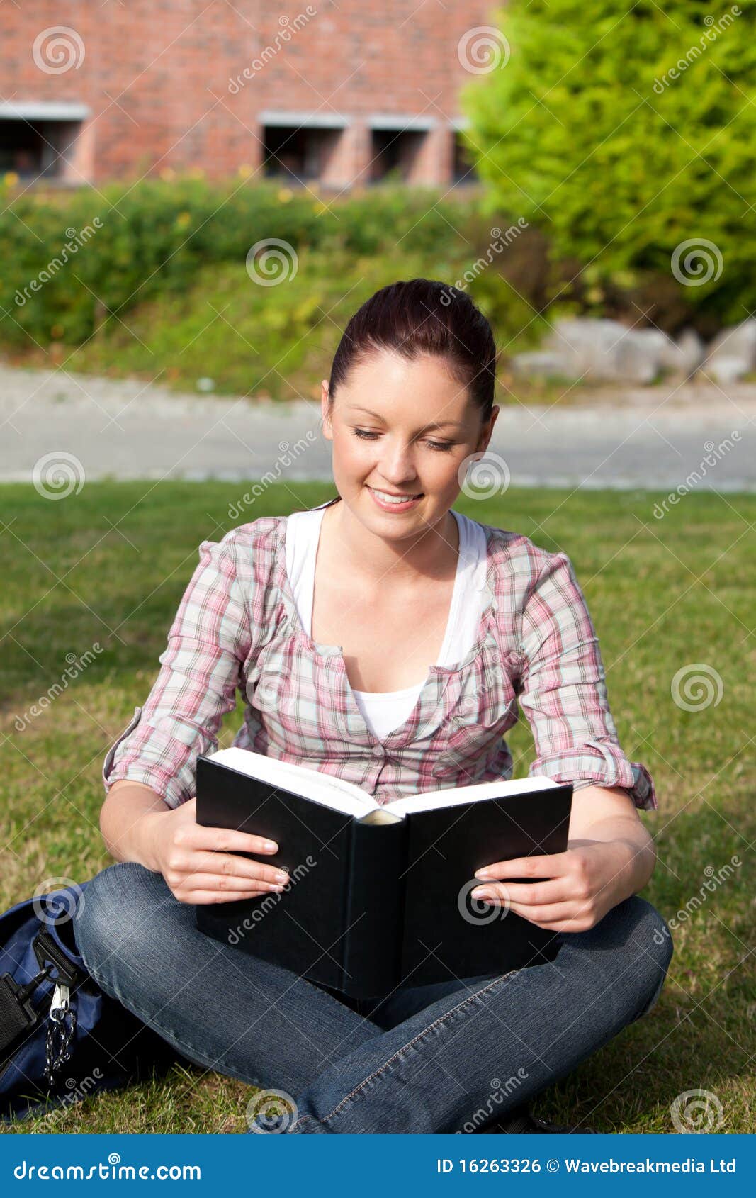 Relaxed Female Student Reading a Book Outdoors Stock Photo - Image of ...