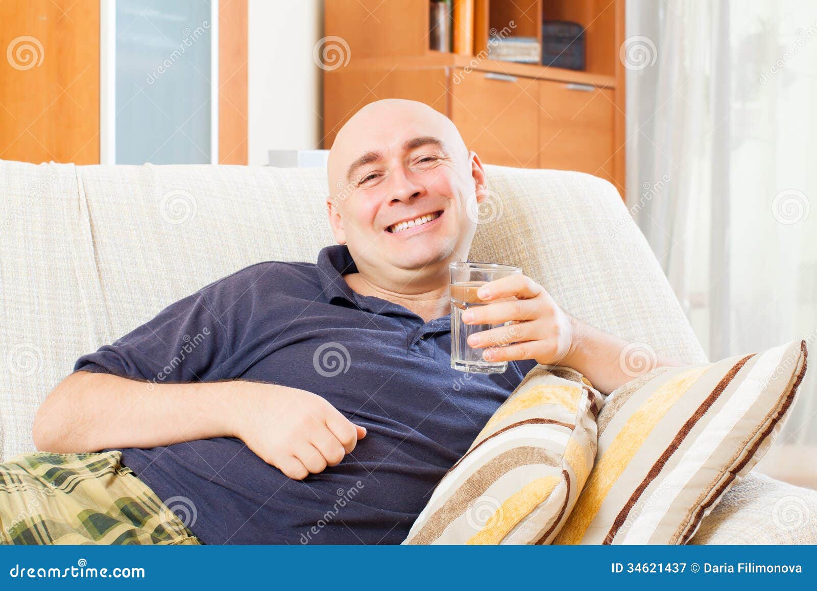 Relaxed man with glass stock image. Image of home, laziness - 34621437