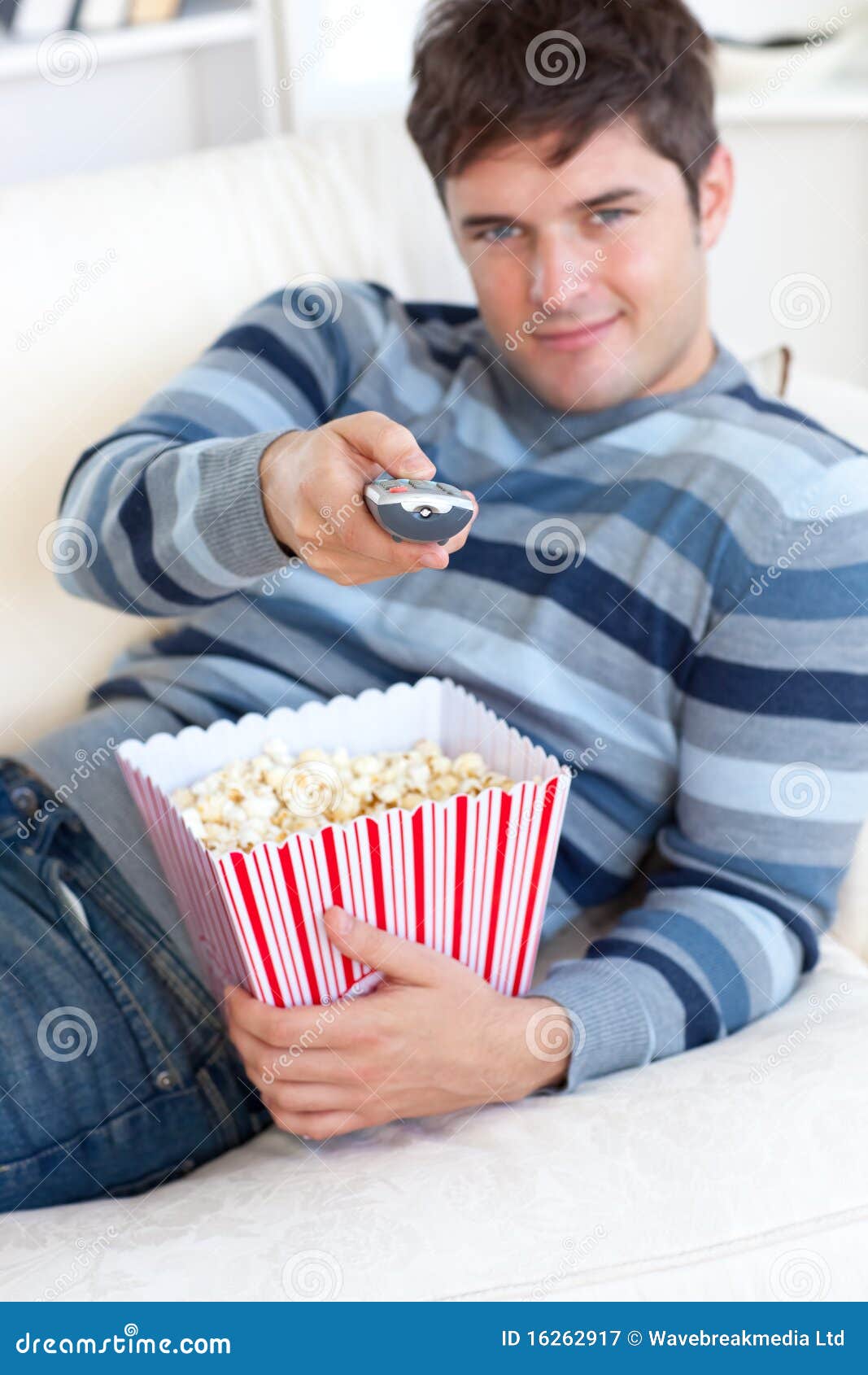Relaxed Man with Popcorn Showing the Remote Stock Image - Image of ...