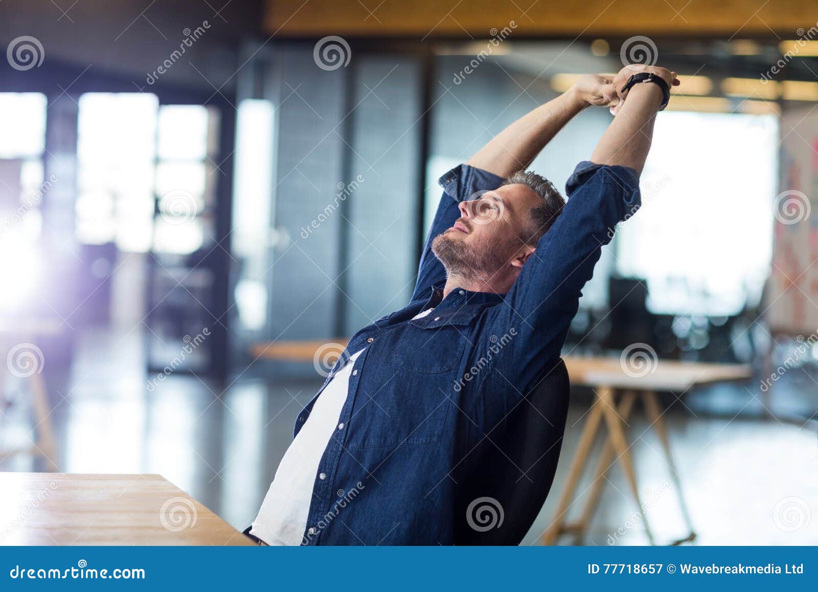 Relaxed Man Sitting in Office Stock Image - Image of male, mature: 77718657