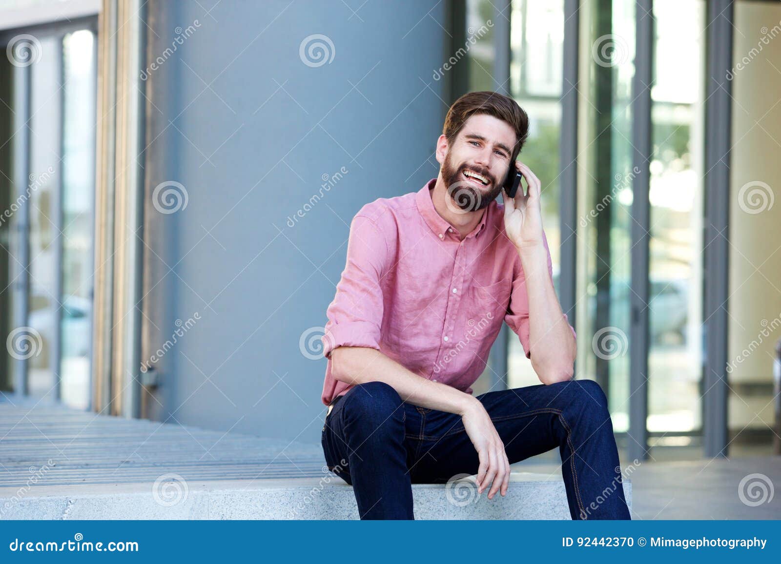 Relaxed Man Sitting Outside Talking on Mobile Phone Stock Photo - Image ...