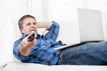 Relaxed Man Using Computer at Home Switching Tv on Stock Image - Image ...