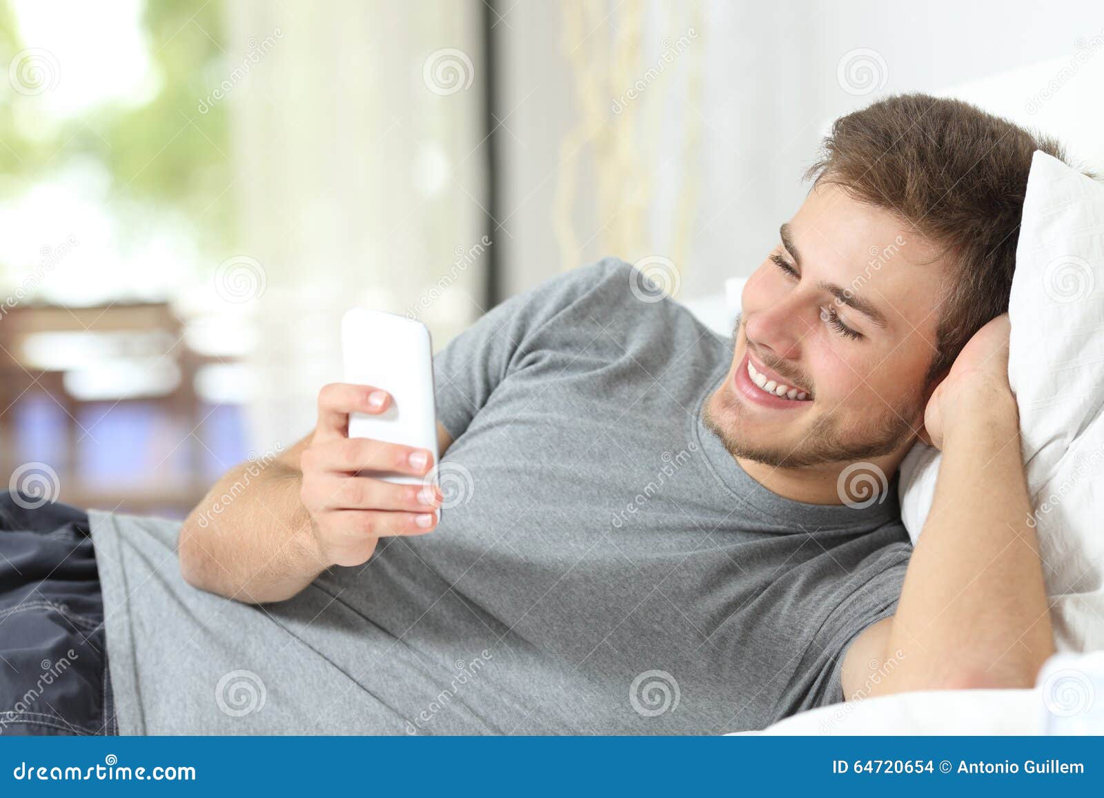 Relaxed Man Using a Smart Phone at Home Stock Photo - Image of home ...