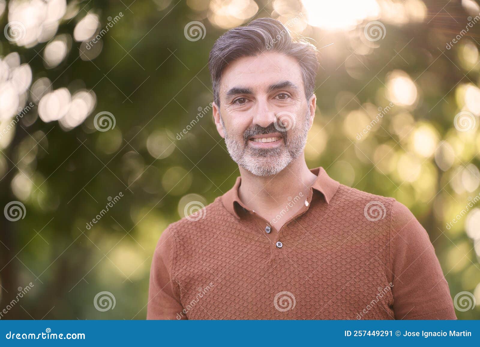 Relaxed Middle-aged Man Looking at Camera while Standing Outdoors in a ...