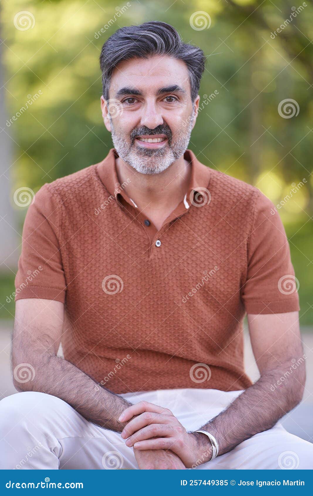 Relaxed Middle-aged Man Looking at Camera while Standing Outdoors in a ...