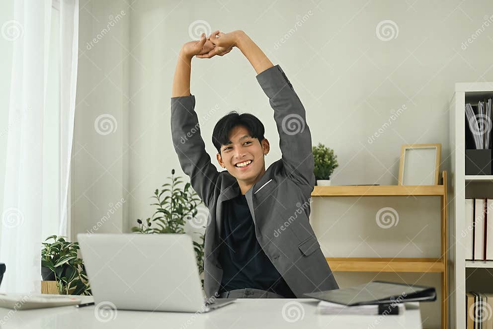 Relaxed Office Worker Stretching after Work Session in the Workplace ...