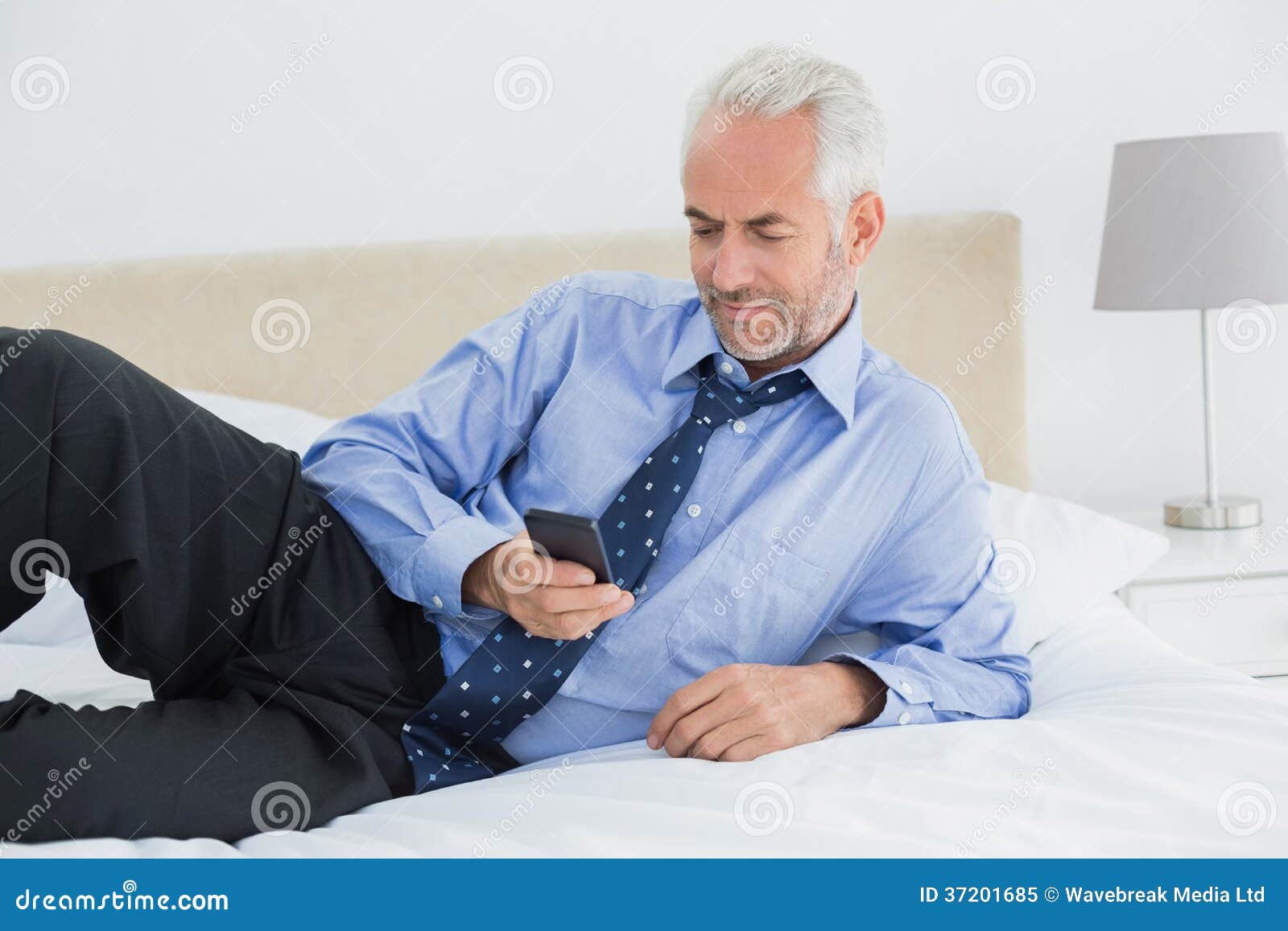 Relaxed Well Dressed Man Text Messaging in Bed Stock Image - Image of ...