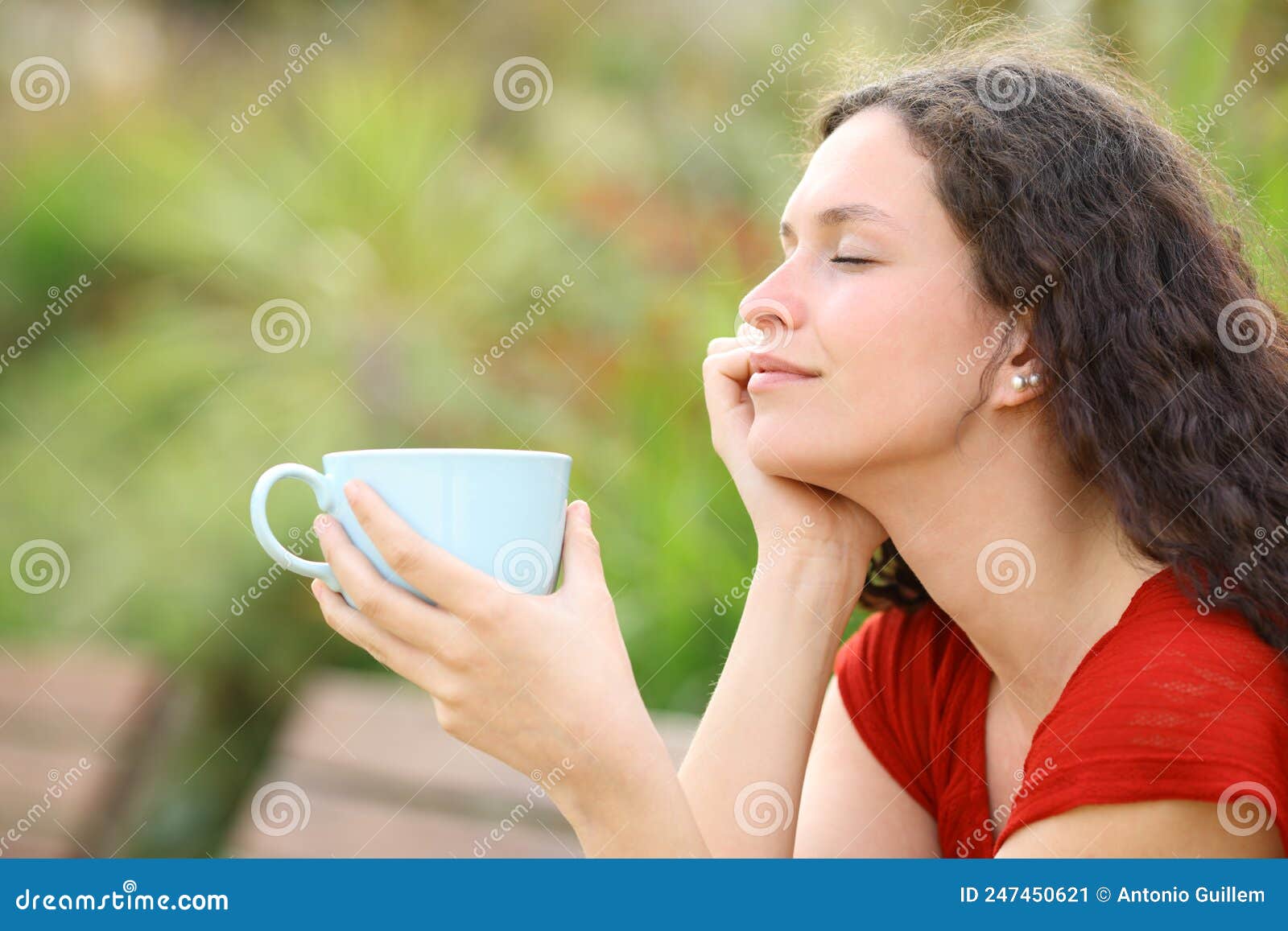 Relaxed Woman Resting Holding a Coffee Cup in a Park Stock Image ...