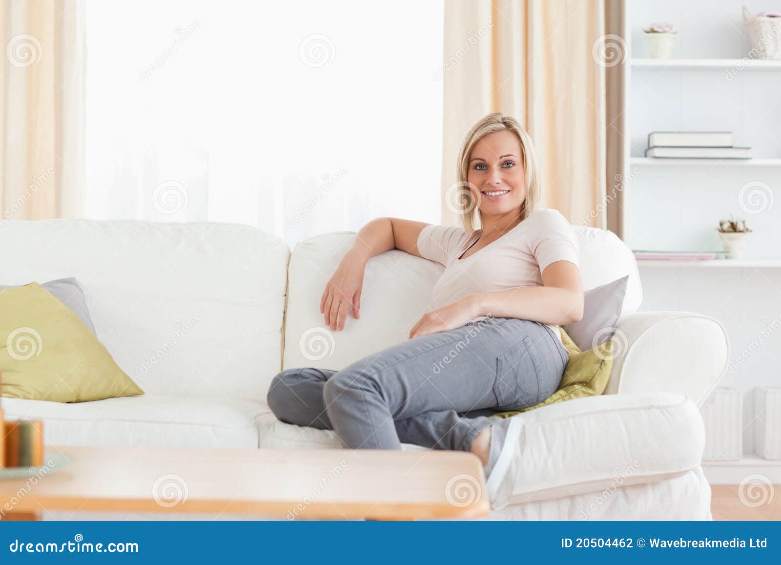 Relaxed Woman Sitting on a Sofa Stock Photo - Image of emotional, light ...