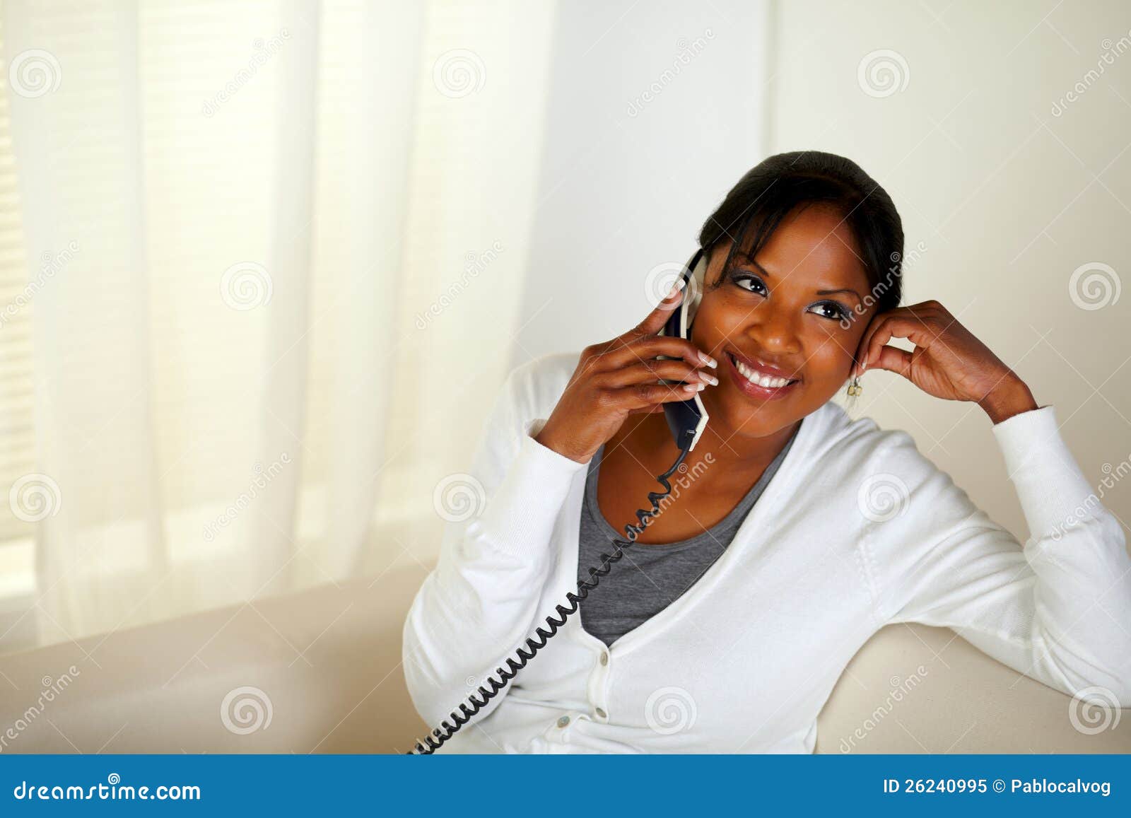 Relaxed Woman Smiling and Conversing on Phone Stock Image - Image of ...
