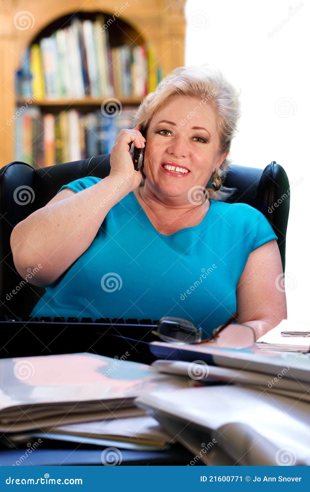 Relaxed Woman Takes Call at Desk Stock Image - Image of bookcase ...