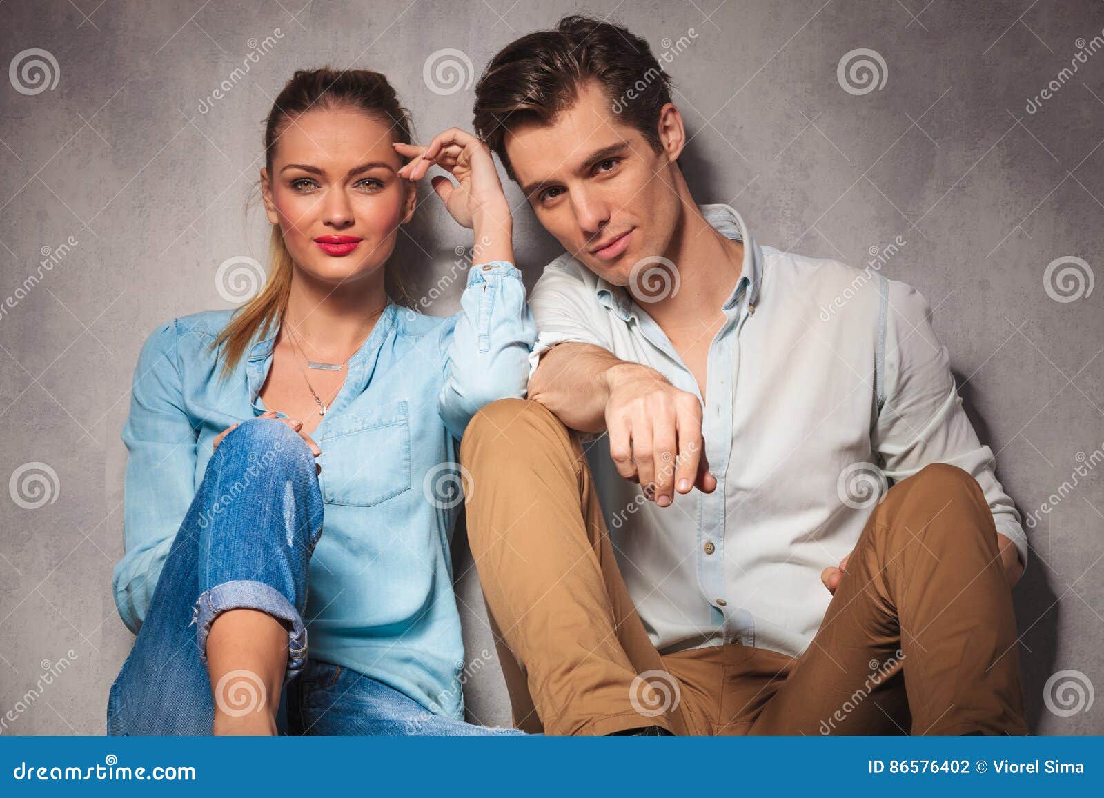 Relaxed Young Casual Couple Sitting Together Stock Photo - Image of ...