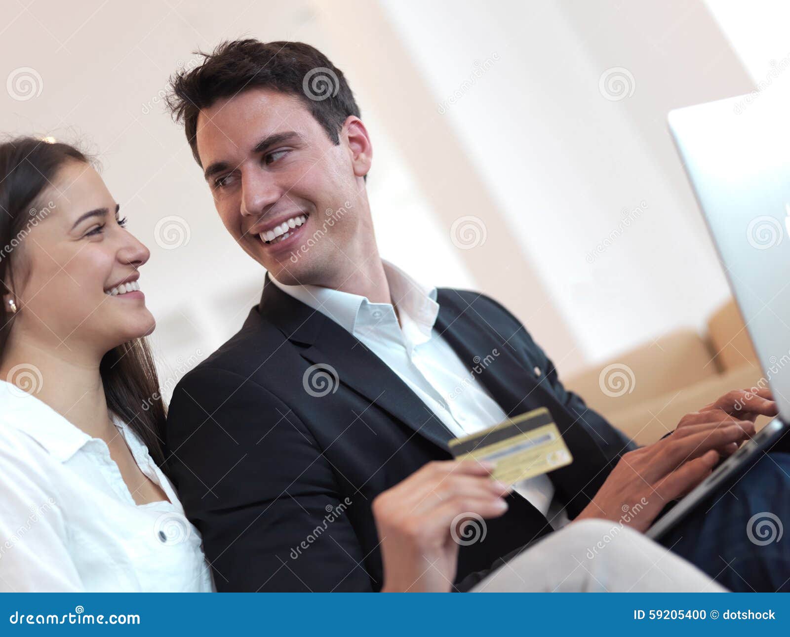 Relaxed Young Couple Working on Laptop Computer at Home Stock Photo ...