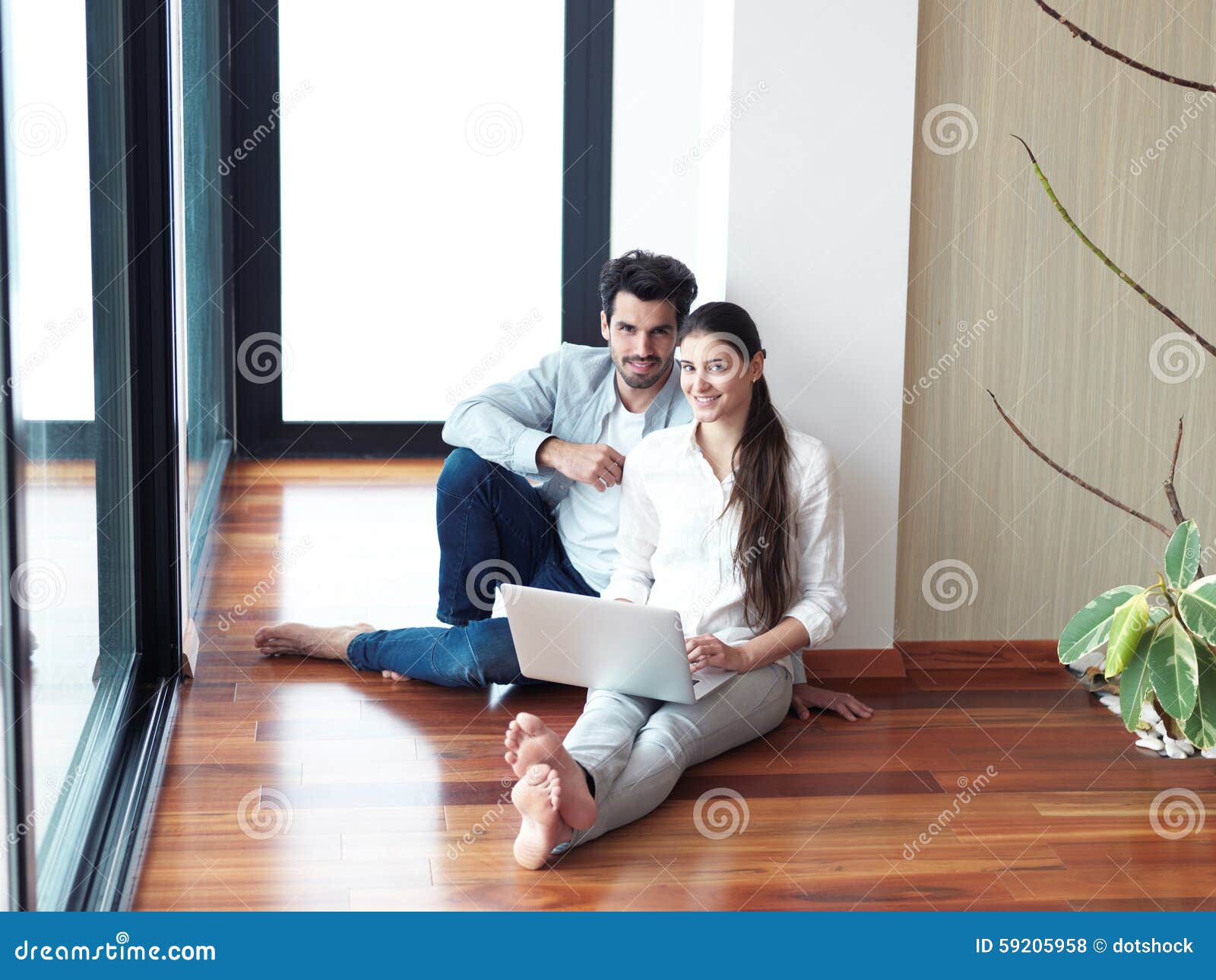 Relaxed Young Couple Working on Laptop Computer at Home Stock Photo ...