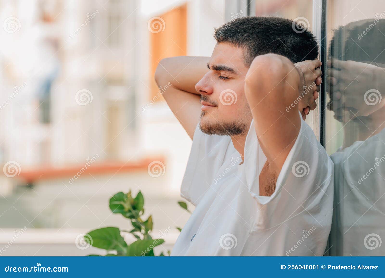 Relaxed Young Man Leaning on Wall Stock Image - Image of leaning ...