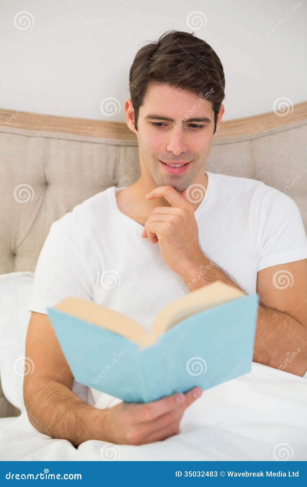 Relaxed Young Man Reading Book in Bed Stock Image - Image of relaxation ...