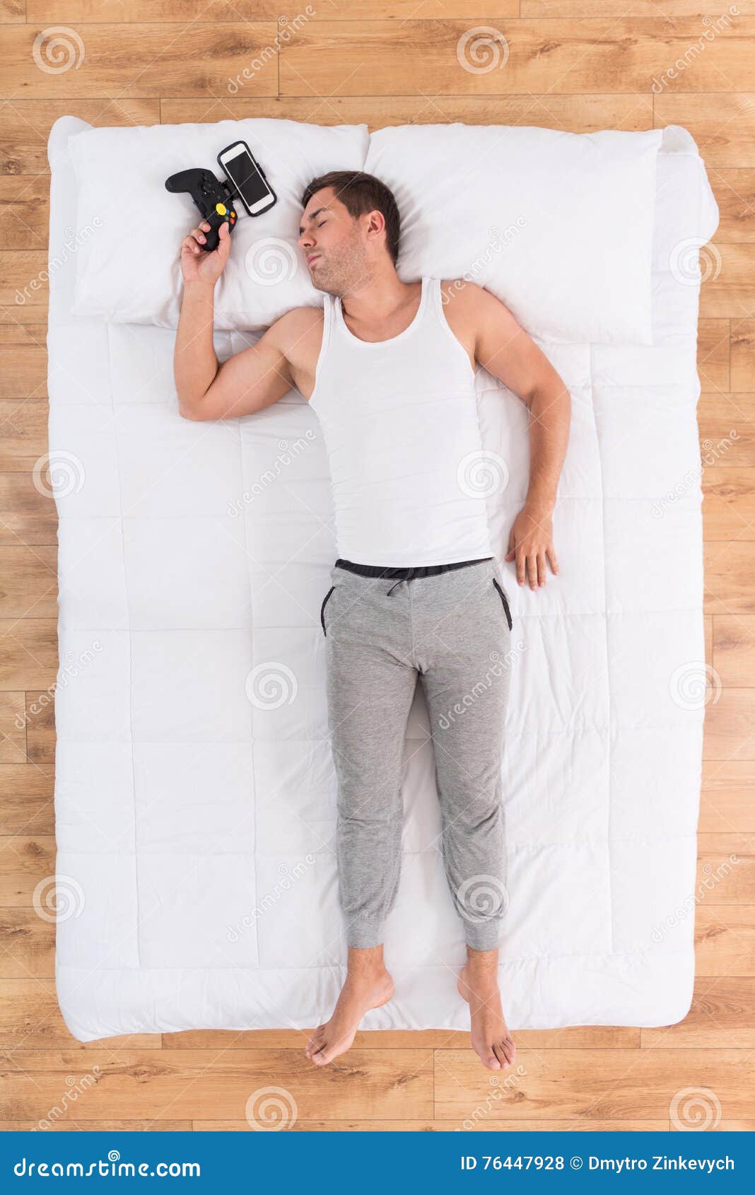 Relaxed Young Man Sleeping on Bed Stock Photo - Image of phone, pillow ...