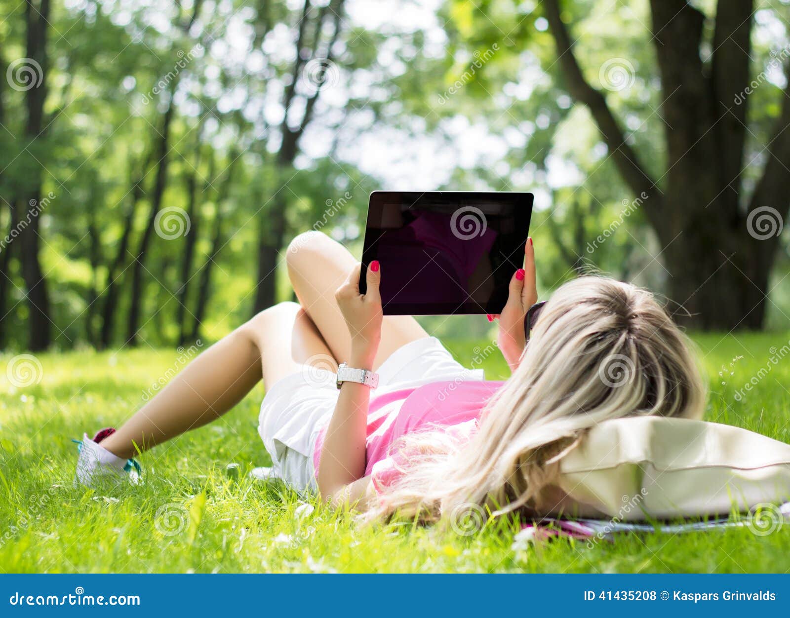 Relaxed Young Woman Using Tablet Computer Outdoors Stock Photo - Image ...