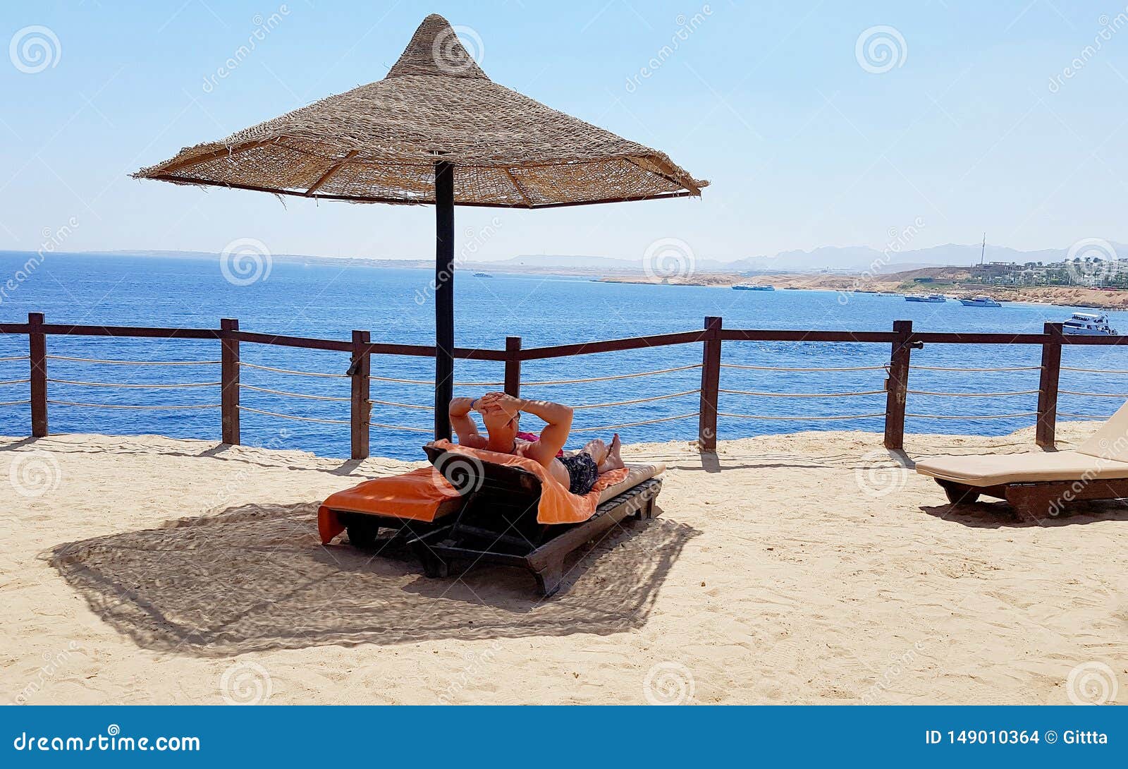 Relaxing on a the Beach in the Shadow Stock Photo - Image of ...