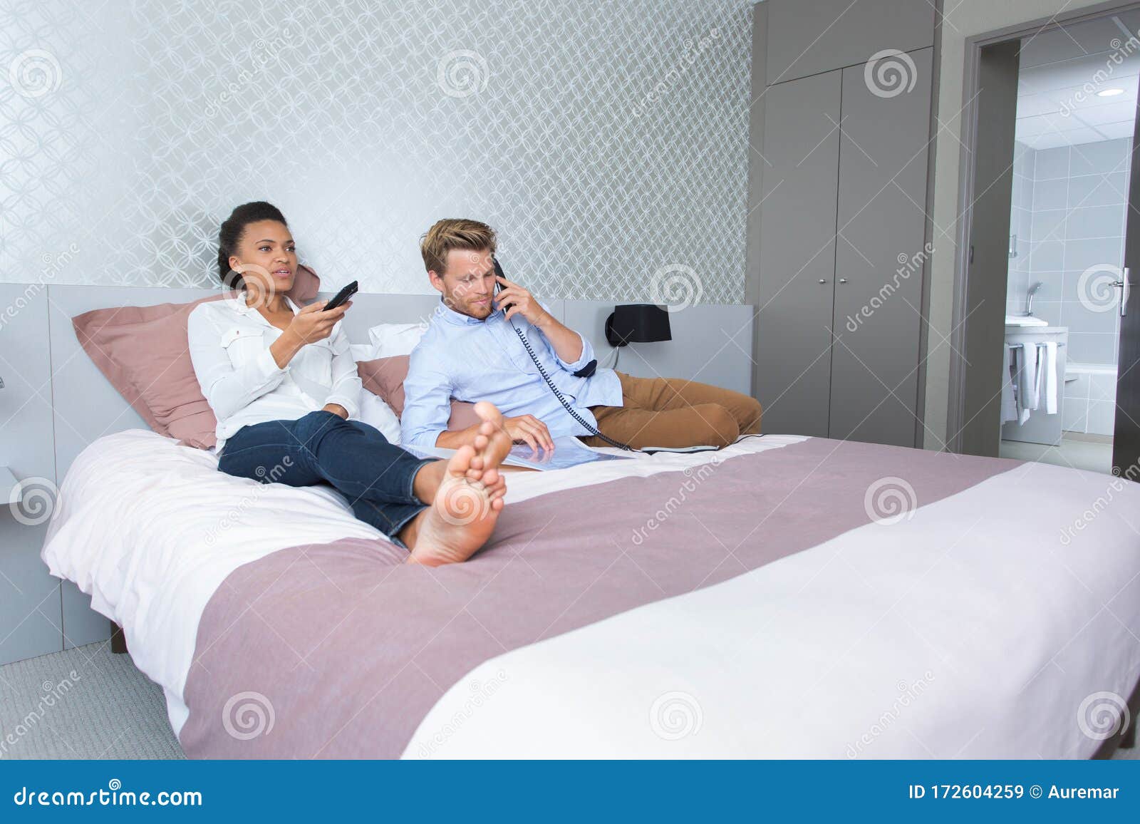 They relaxing on bed stock image. Image of relax, television - 172604259
