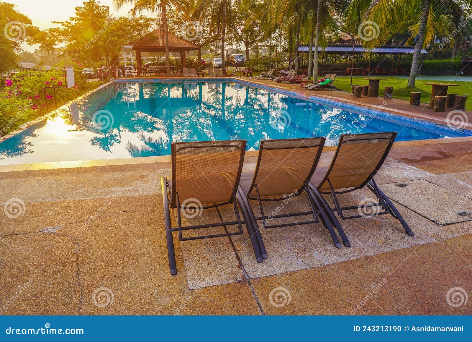 Relaxing on a Bench beside Swimming Pool during Sunrise Stock Photo ...