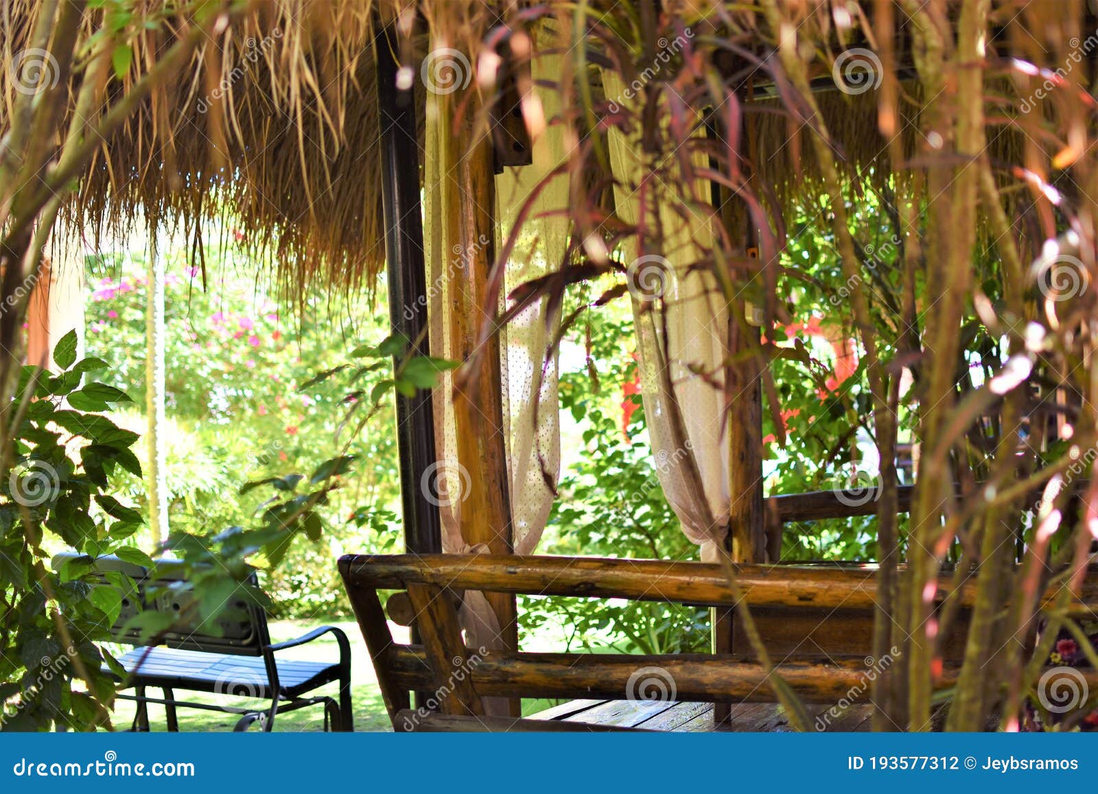A Relaxing Garden with a Bench and a Native Gazebo Stock Photo - Image ...