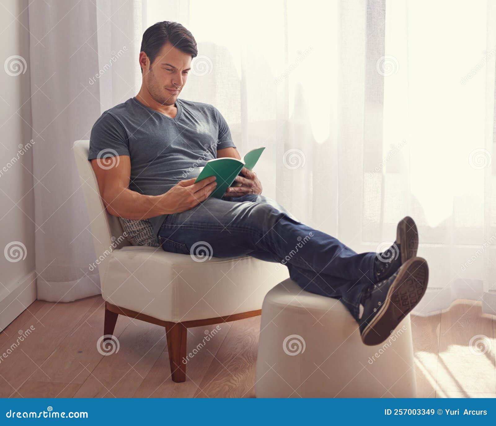 Relaxing with a Good Book. a Handsome Young Man Relaxing with a Book at ...