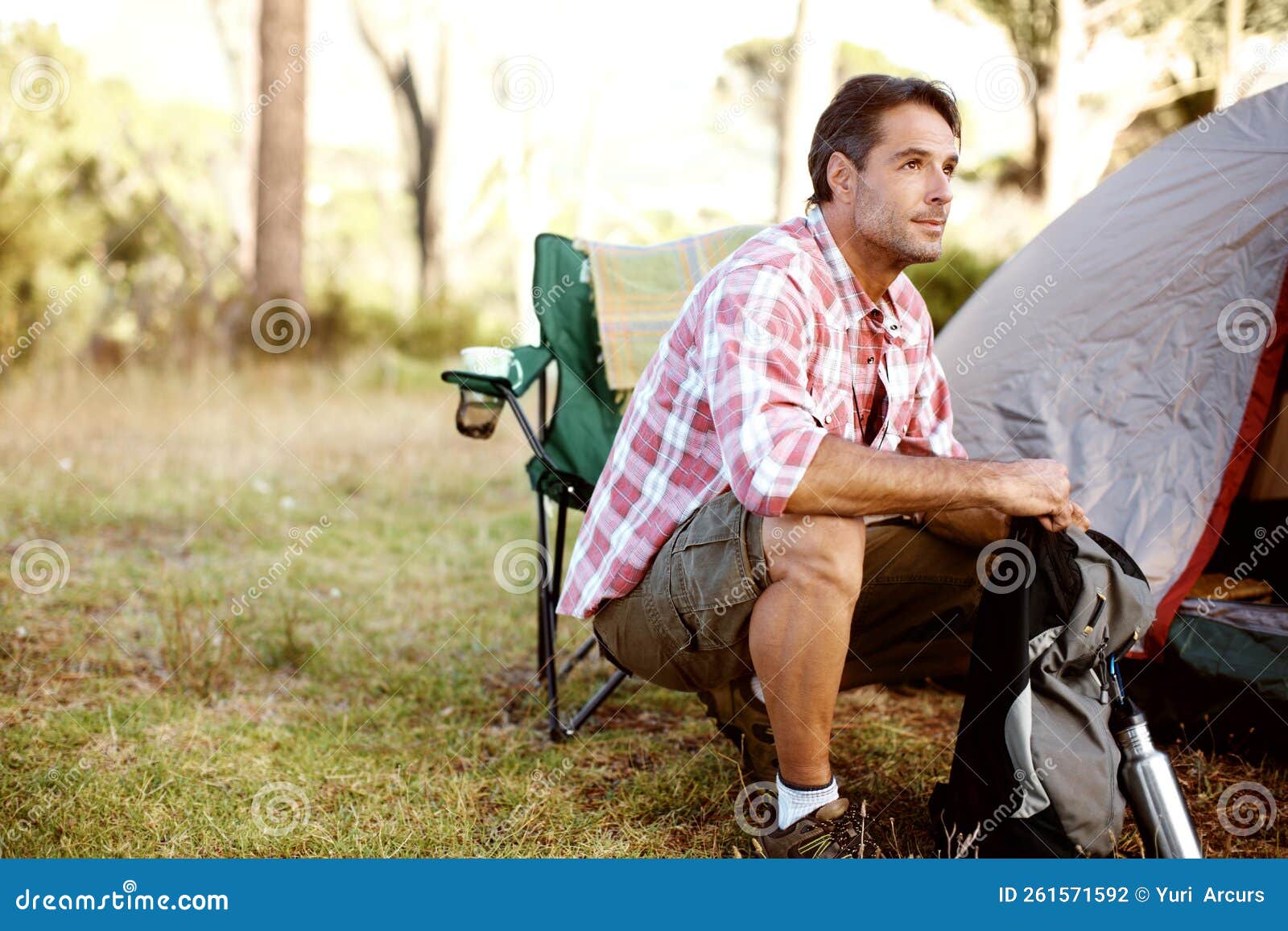 Relaxing in the Great Outdoors. a Handsome Young Man Sitting by His ...