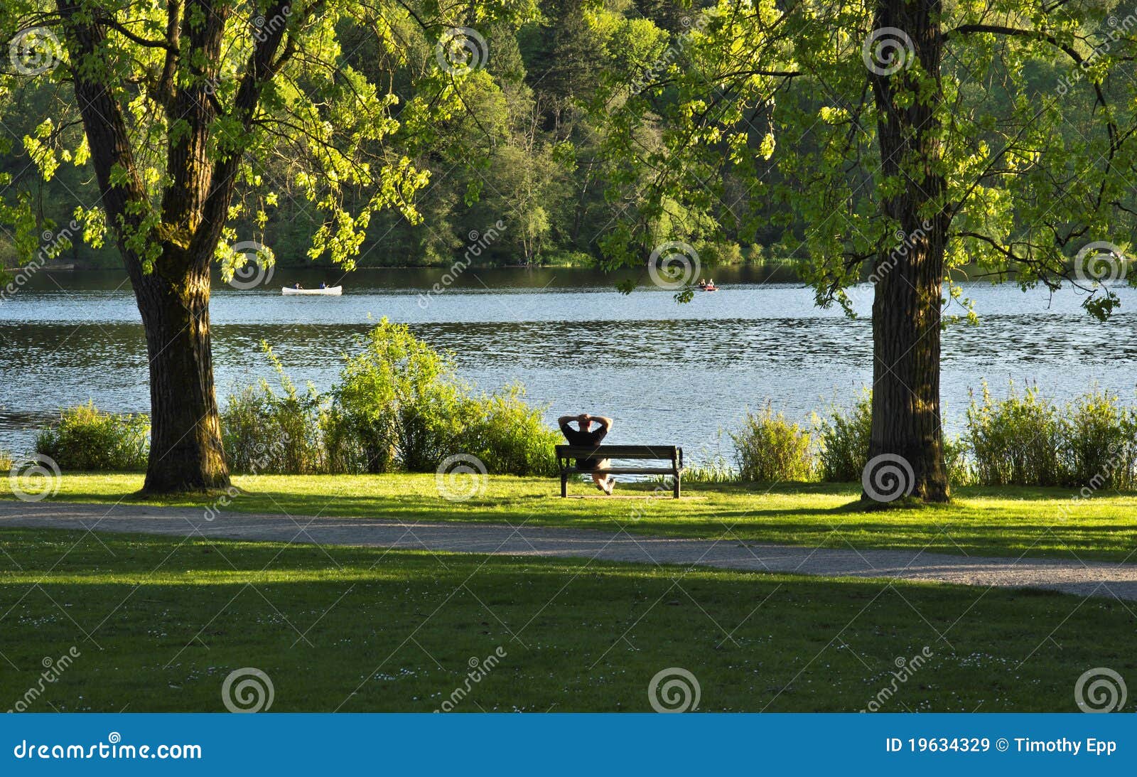 Relaxing beside a lake stock image. Image of bench, activities - 19634329