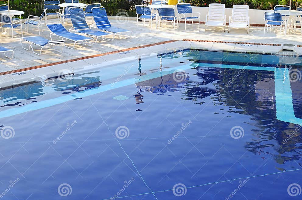 Relaxing pool area stock photo. Image of affluence, relaxation - 12181420