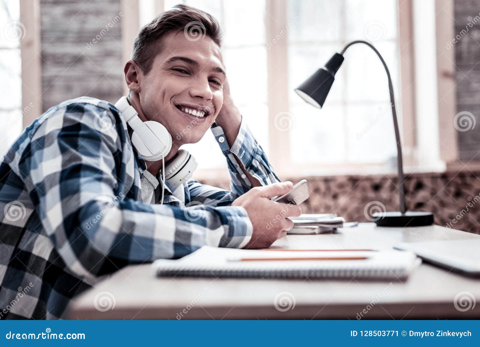 Handsome Student Relaxing while Doing Homework and Smiling Stock Image ...